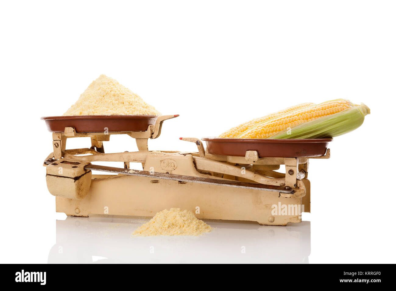 Corncob and corn flour on old scale. Isolated on white background Stock ...