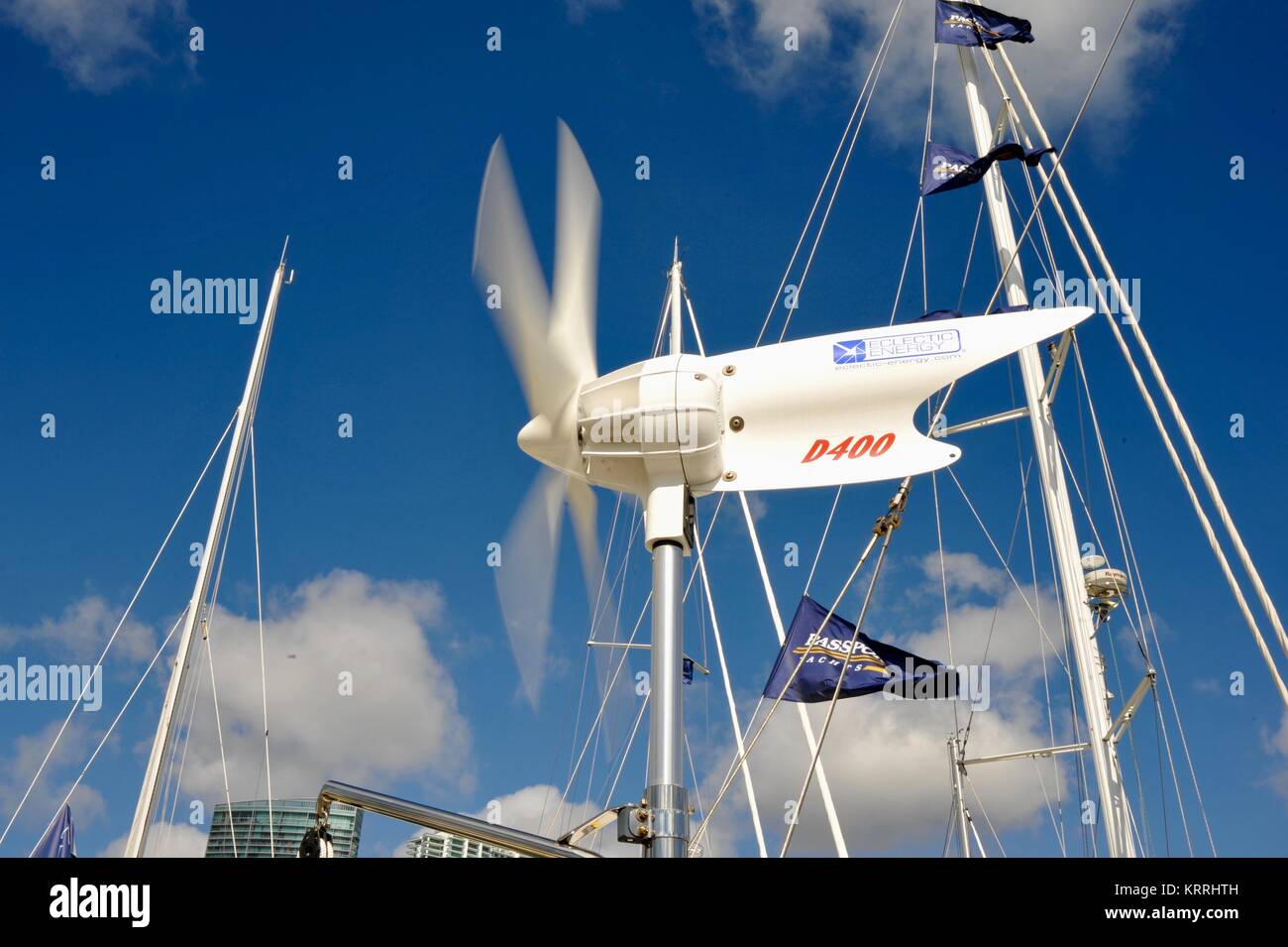 Small wind turbine generating electricity from wind on sailboat docked ...