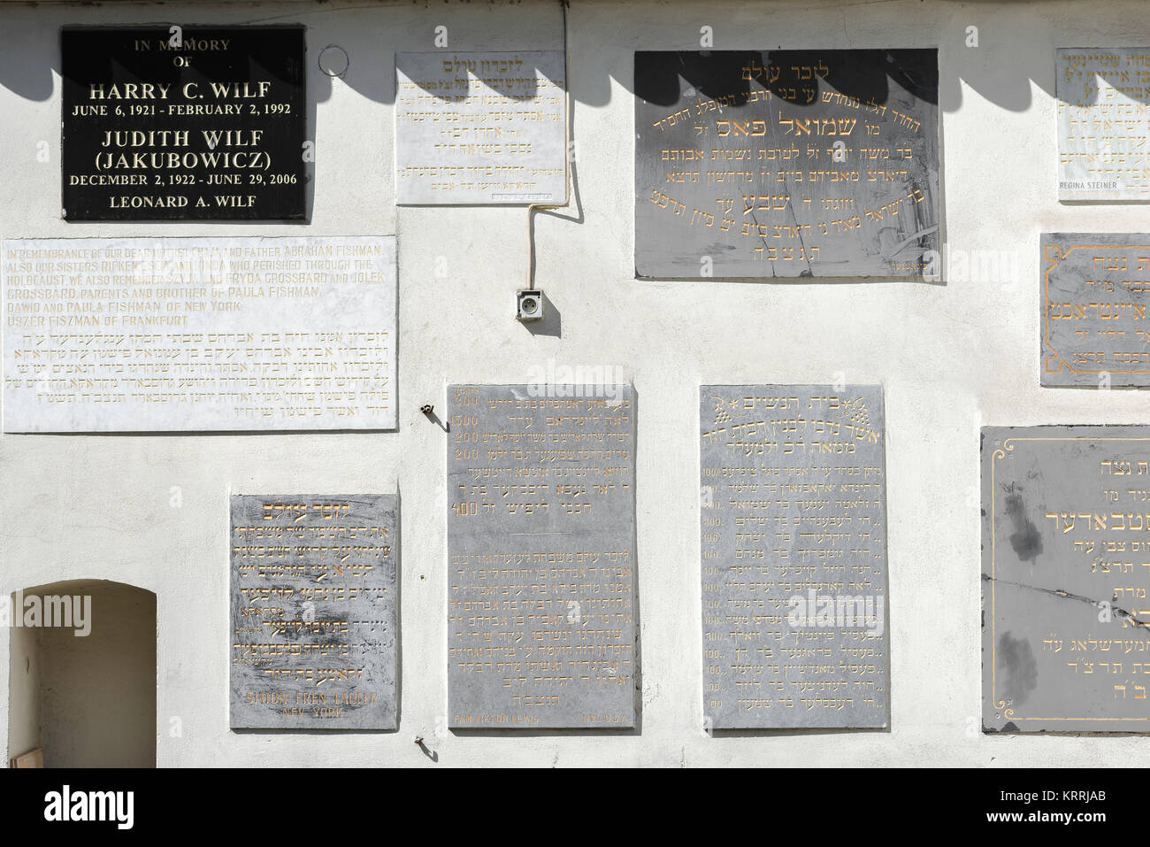 Jewish cemetery wall, family memorial plaques fixed to the cemetery ...