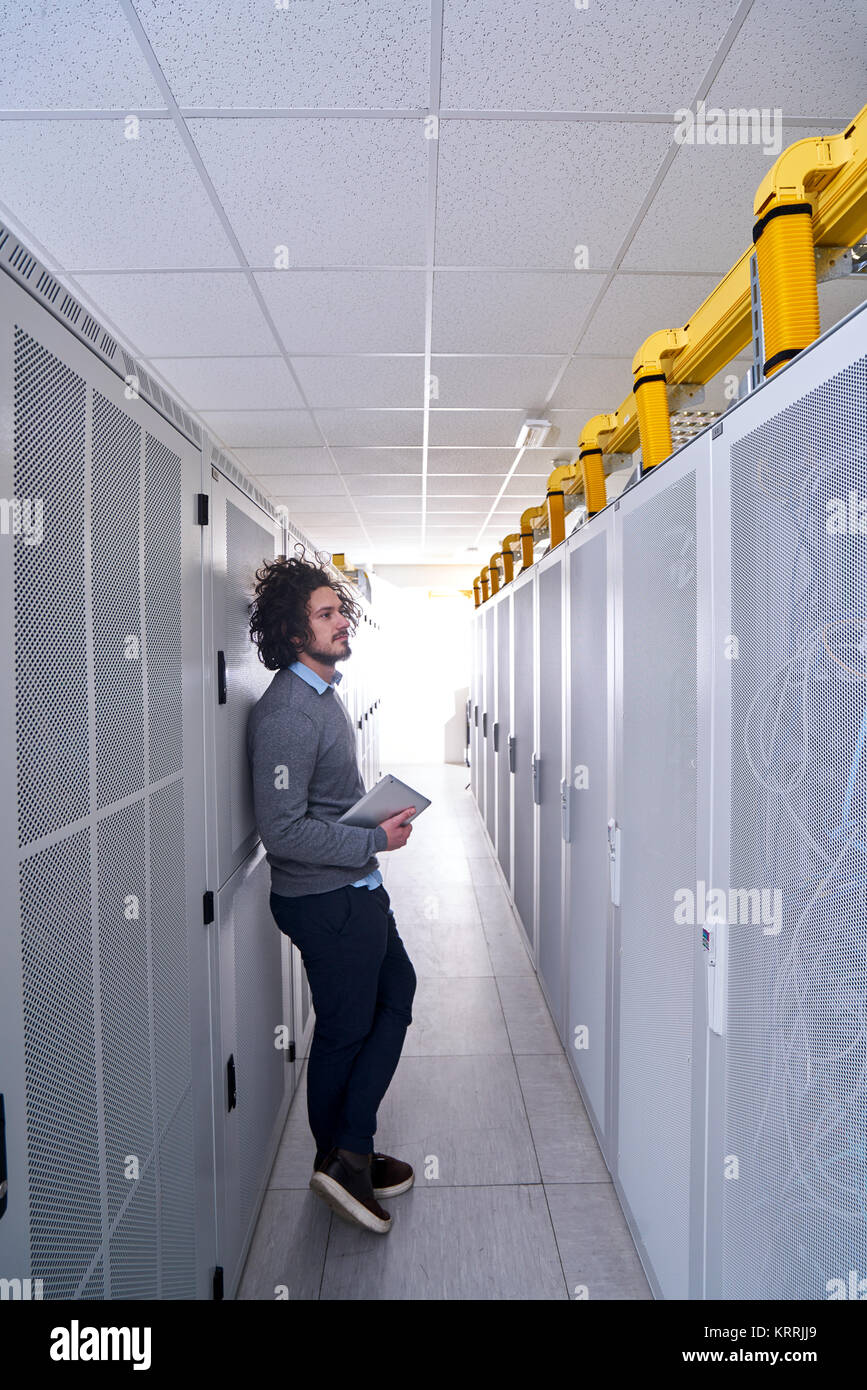 Young technician working in white server room Stock Photo - Alamy