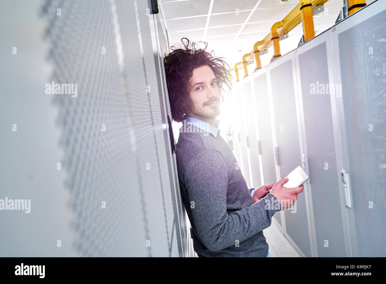 Young technician working in white server room Stock Photo - Alamy
