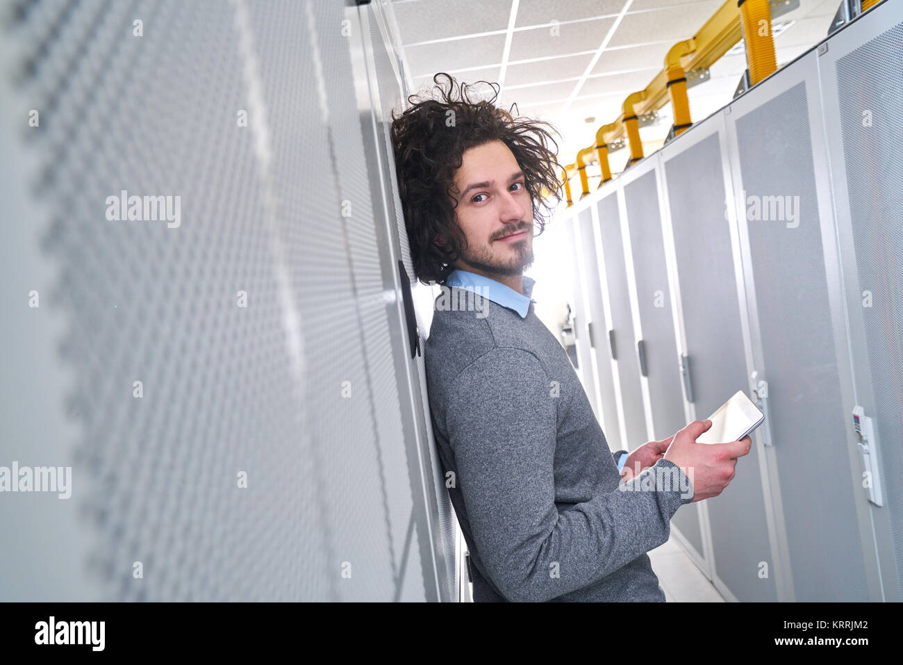 Young technician working in white server room Stock Photo - Alamy