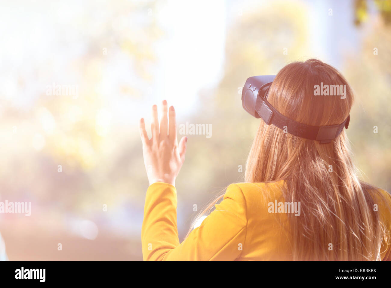 Pretty girl using VR headset outside in the park having fun Stock Photo ...
