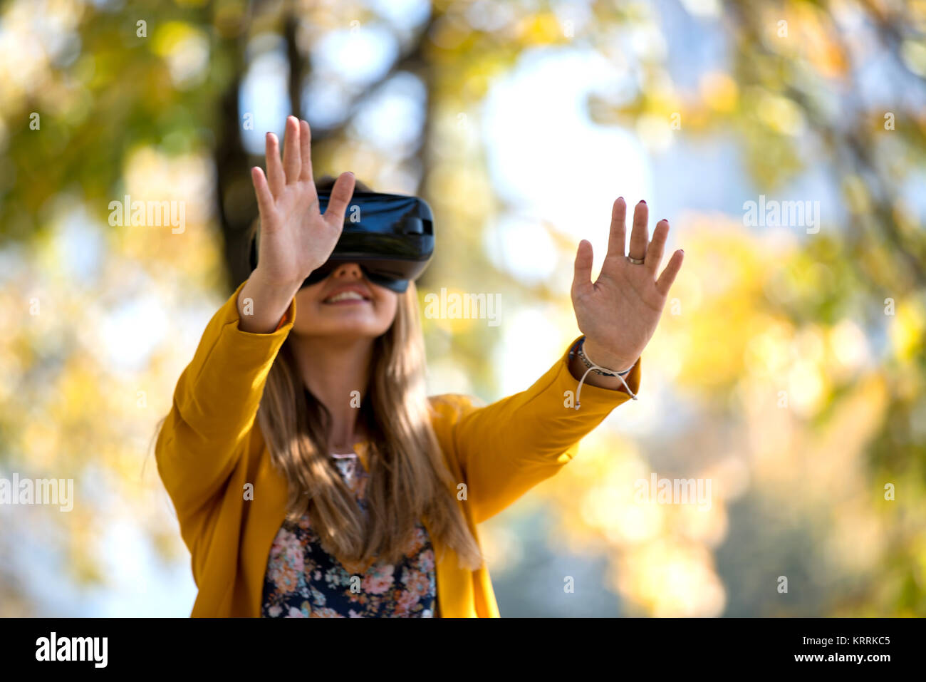 Pretty girl using VR headset outside in the park having fun Stock Photo ...