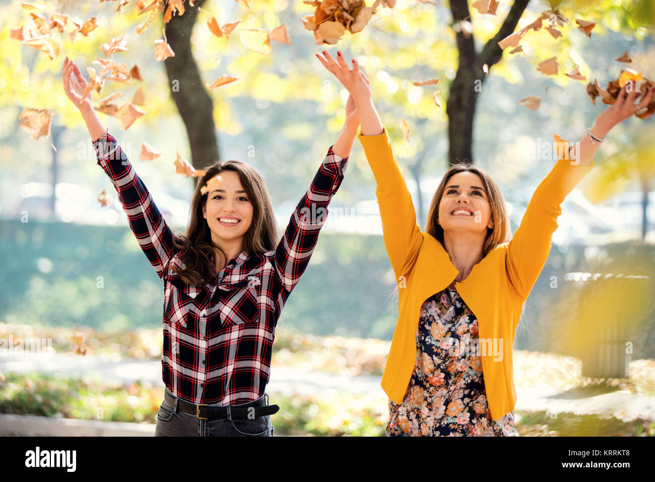 Having fun outside in the late autumn. playing with yellow leaves, fun ...