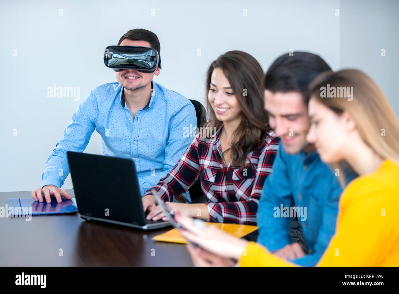 Team of motivated people using various devices at a startup metting ...