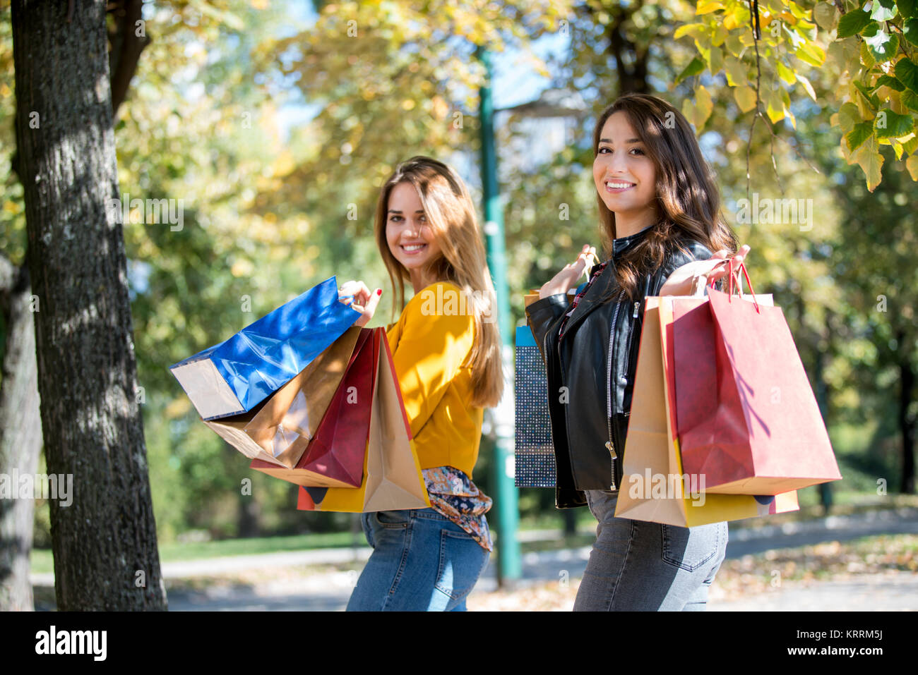 Happy girls shopping in late autumn. bags, walking, holidays Stock ...