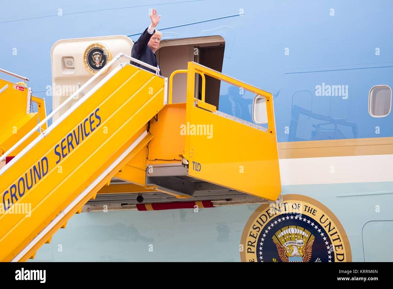 U.S. President Donald Trump waves goodbye as he boards the Air Force ...