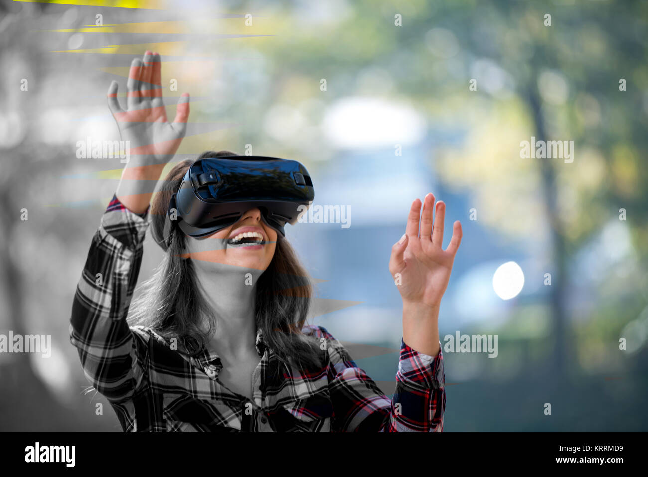 Pretty girl using VR headset outside in the park having fun Stock Photo ...