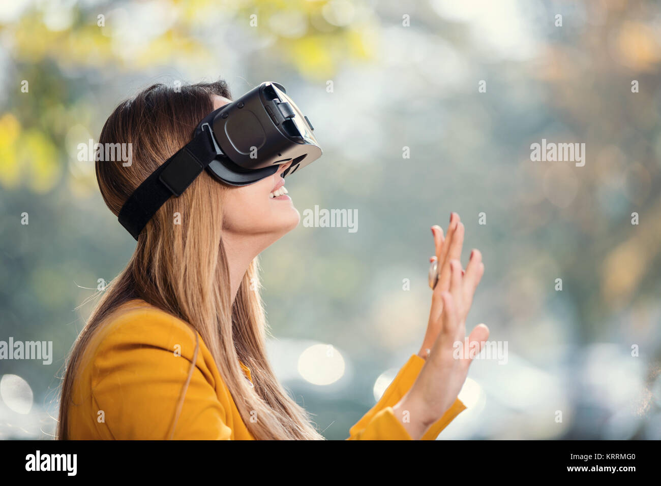 Pretty girl using VR headset outside in the park having fun Stock Photo ...