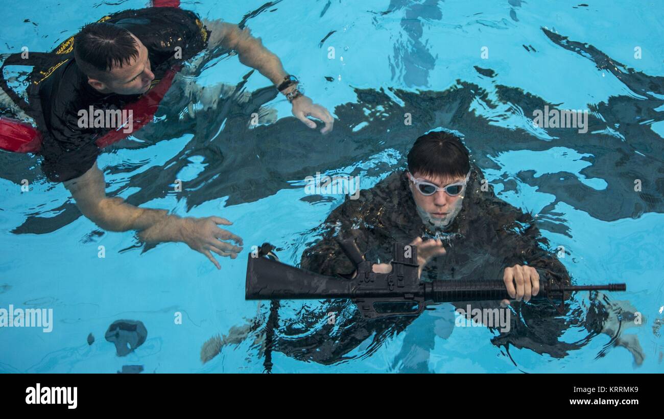 U.S. Marine Corps soldiers carry rifles while treading water during a ...