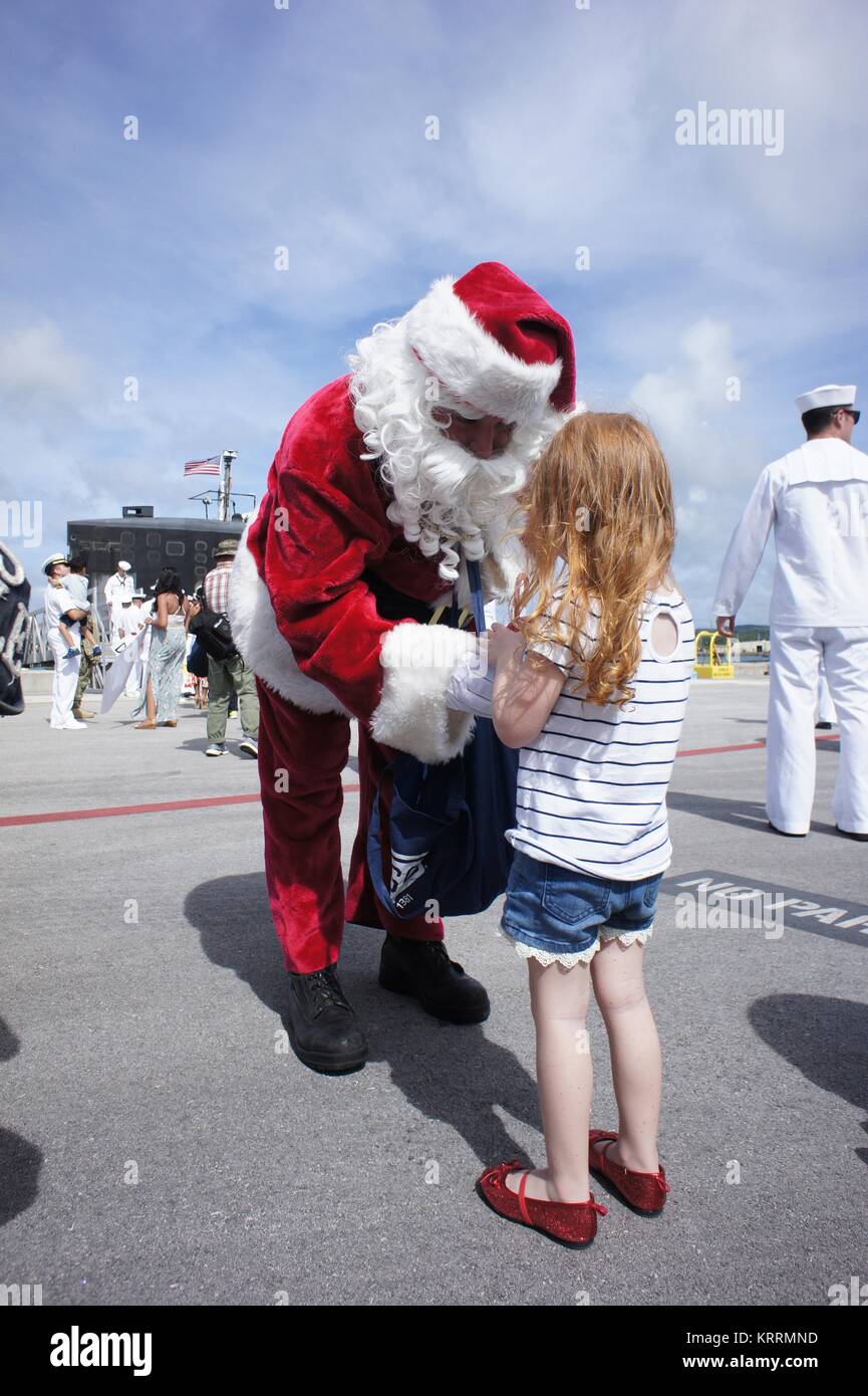 Santa Claus gives out candy canes to children during the U.S. Navy Los ...
