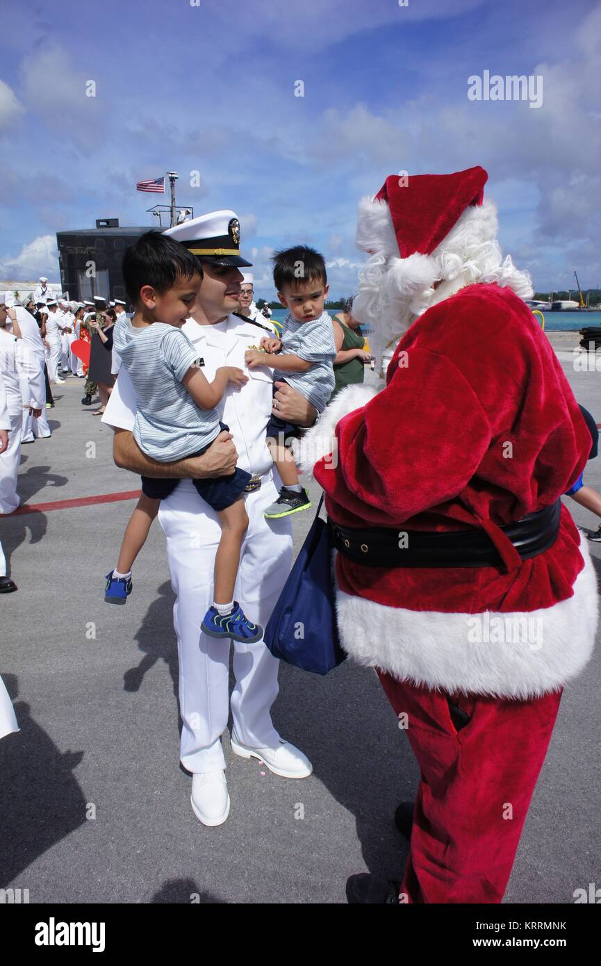 Santa Claus gives out candy canes to children during the U.S. Navy Los ...