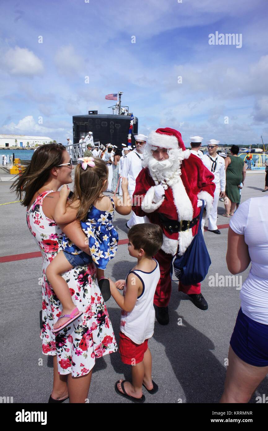 Santa Claus gives out candy canes to children during the U.S. Navy Los ...