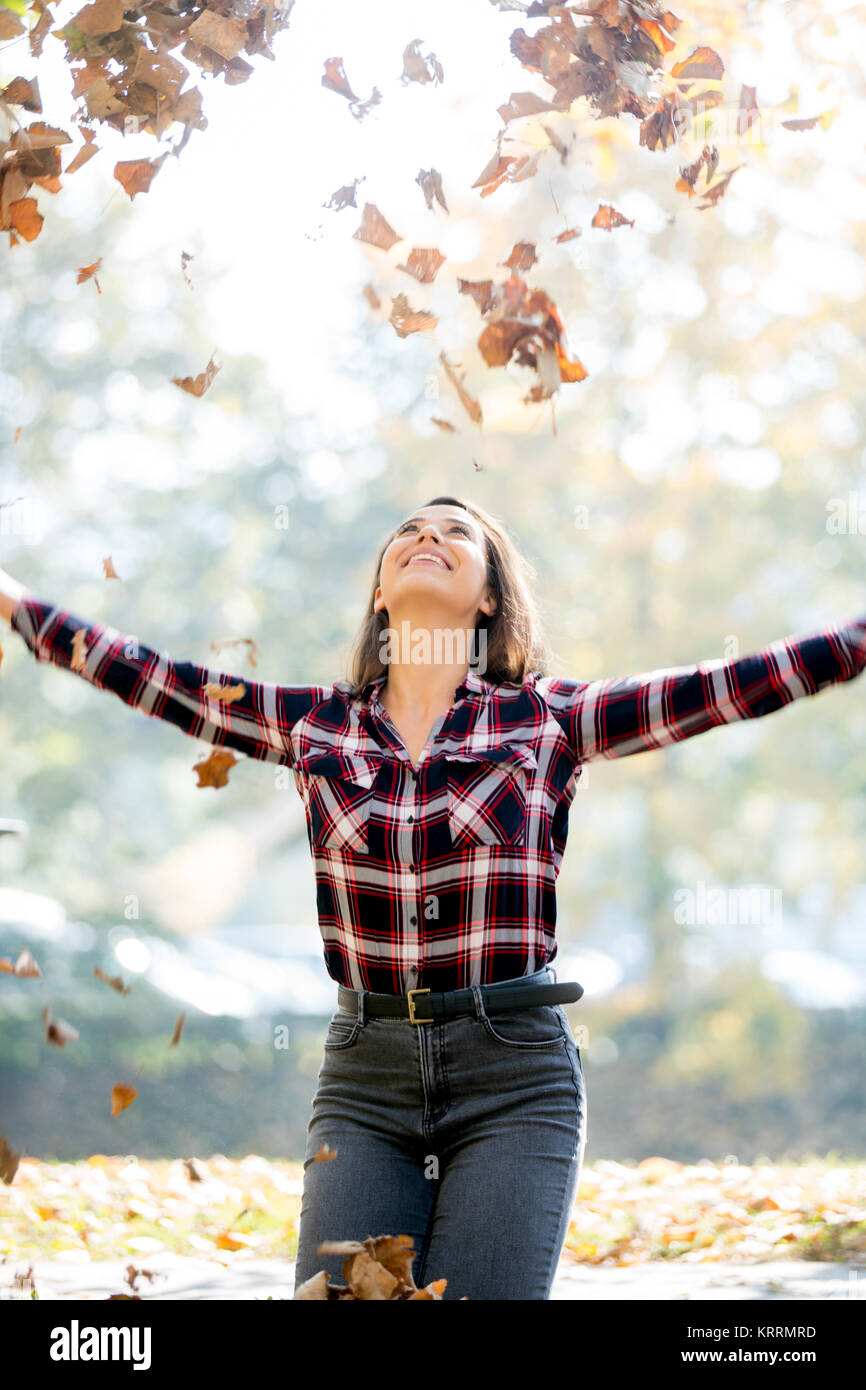 Having fun outside in the late autumn. playing with yellow leaves, fun ...