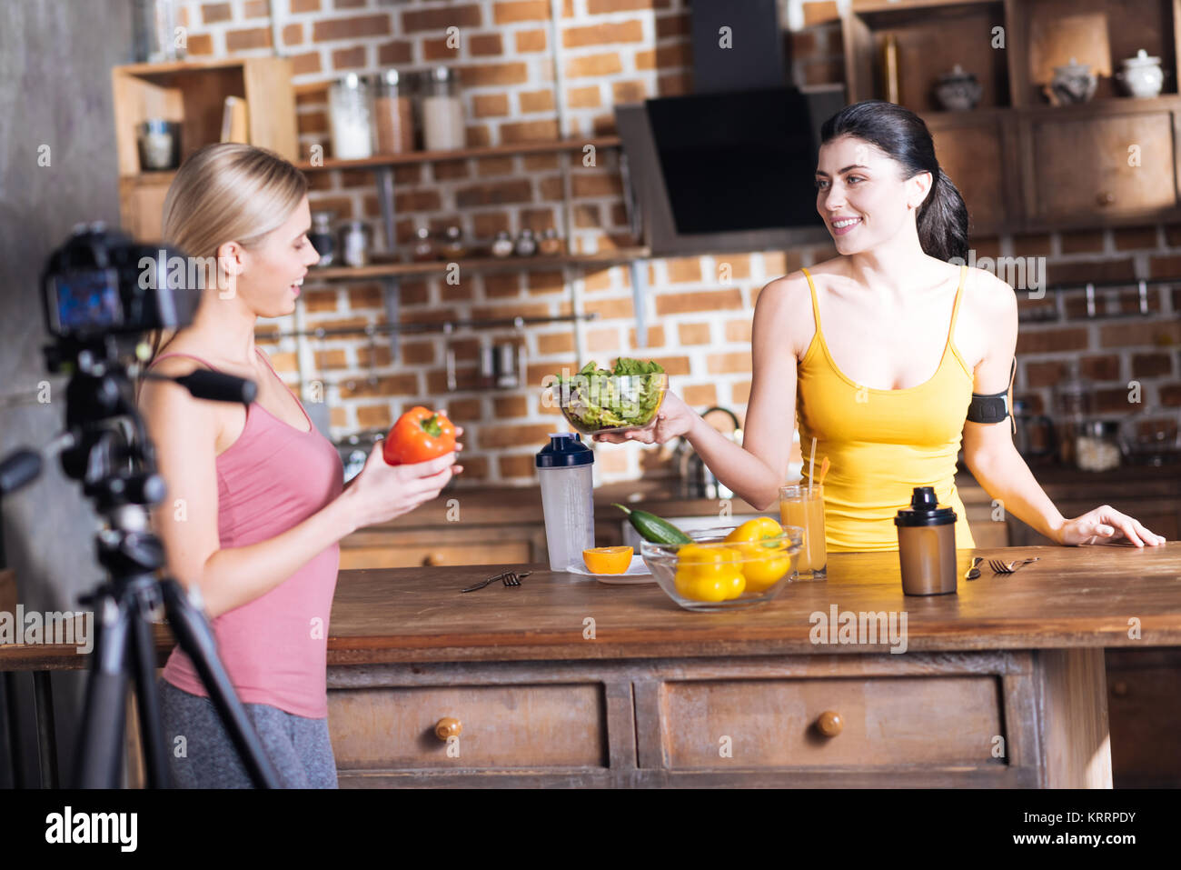 Delighted young women eating vegetables Stock Photo - Alamy