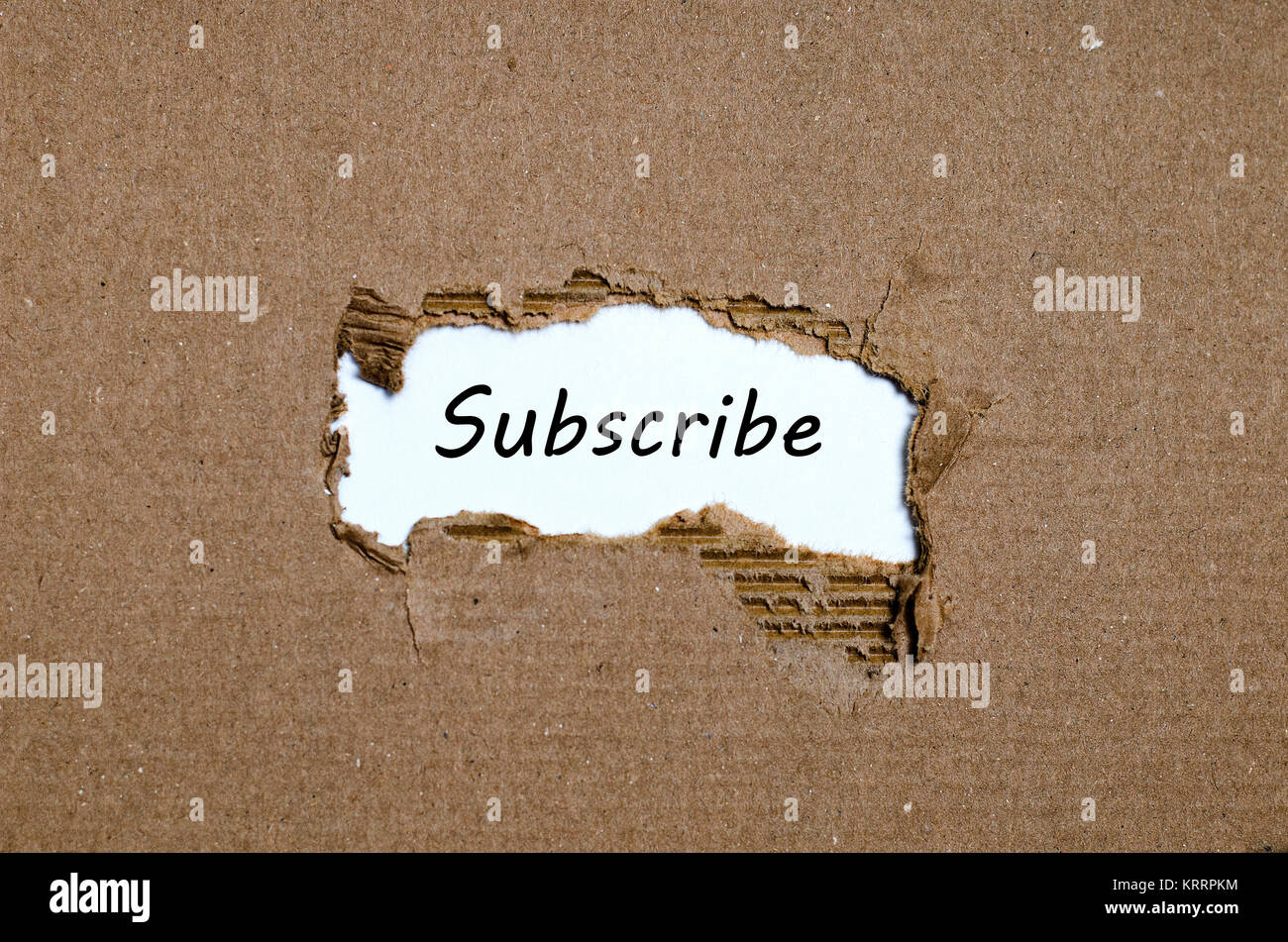 The word subscribe appearing behind torn paper Stock Photo - Alamy