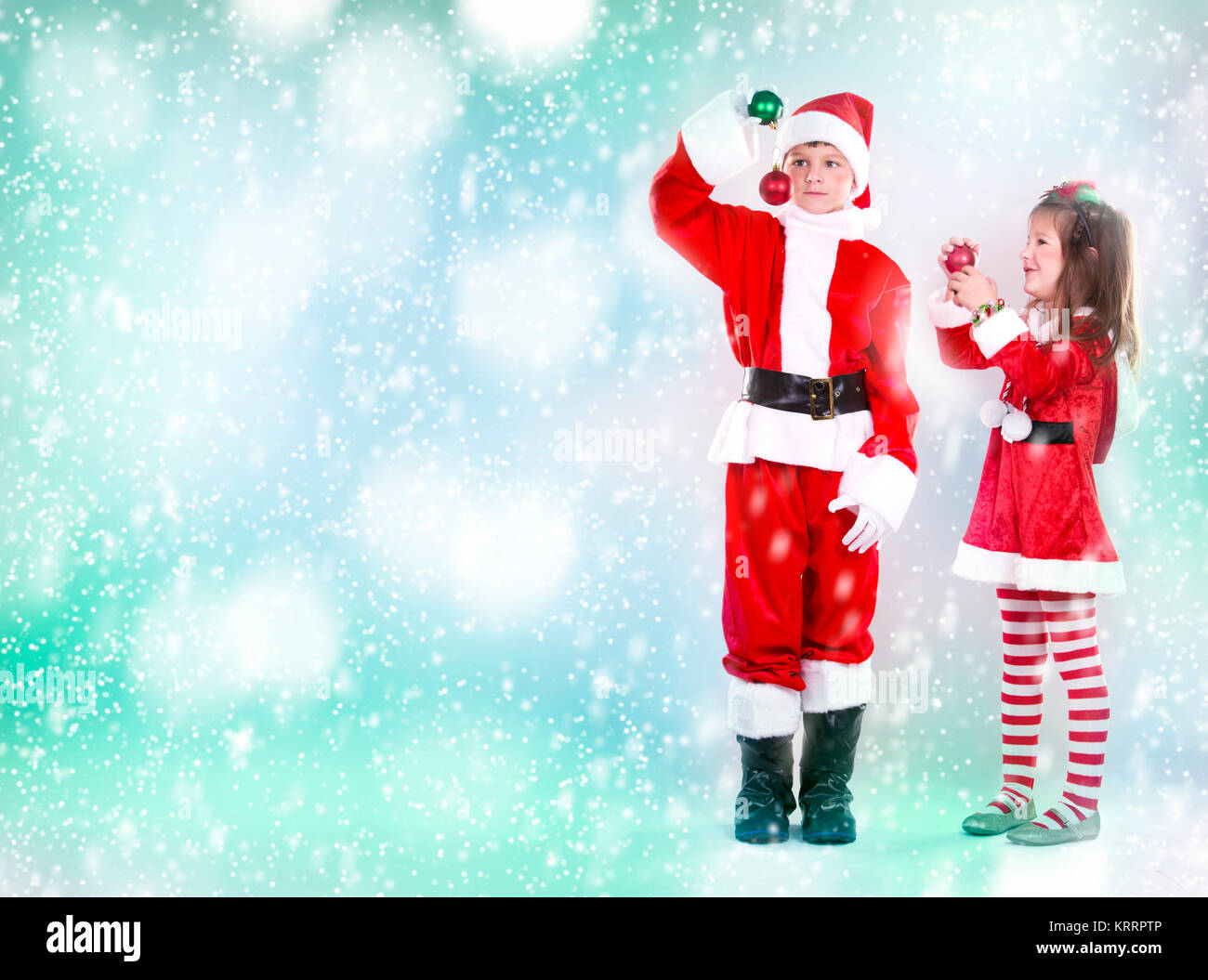 boy and girl as santa and elf Stock Photo - Alamy