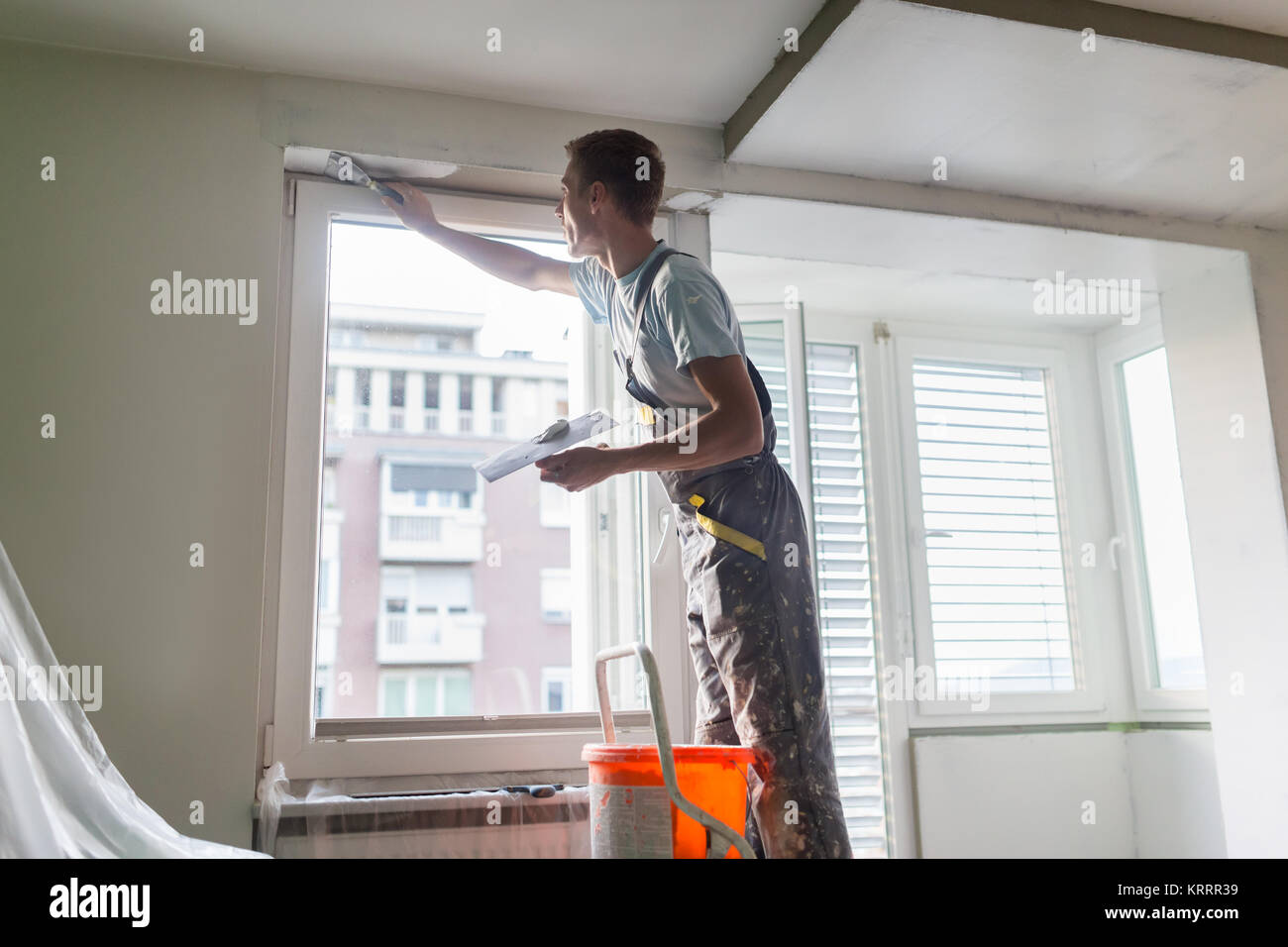 Plasterer renovating indoor walls and ceilings Stock Photo - Alamy
