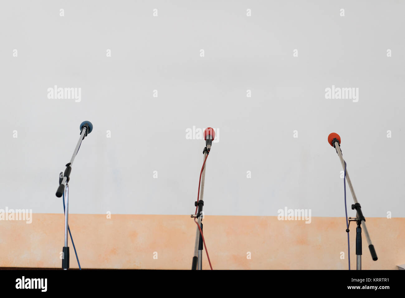 Three microphones on stands Stock Photo - Alamy