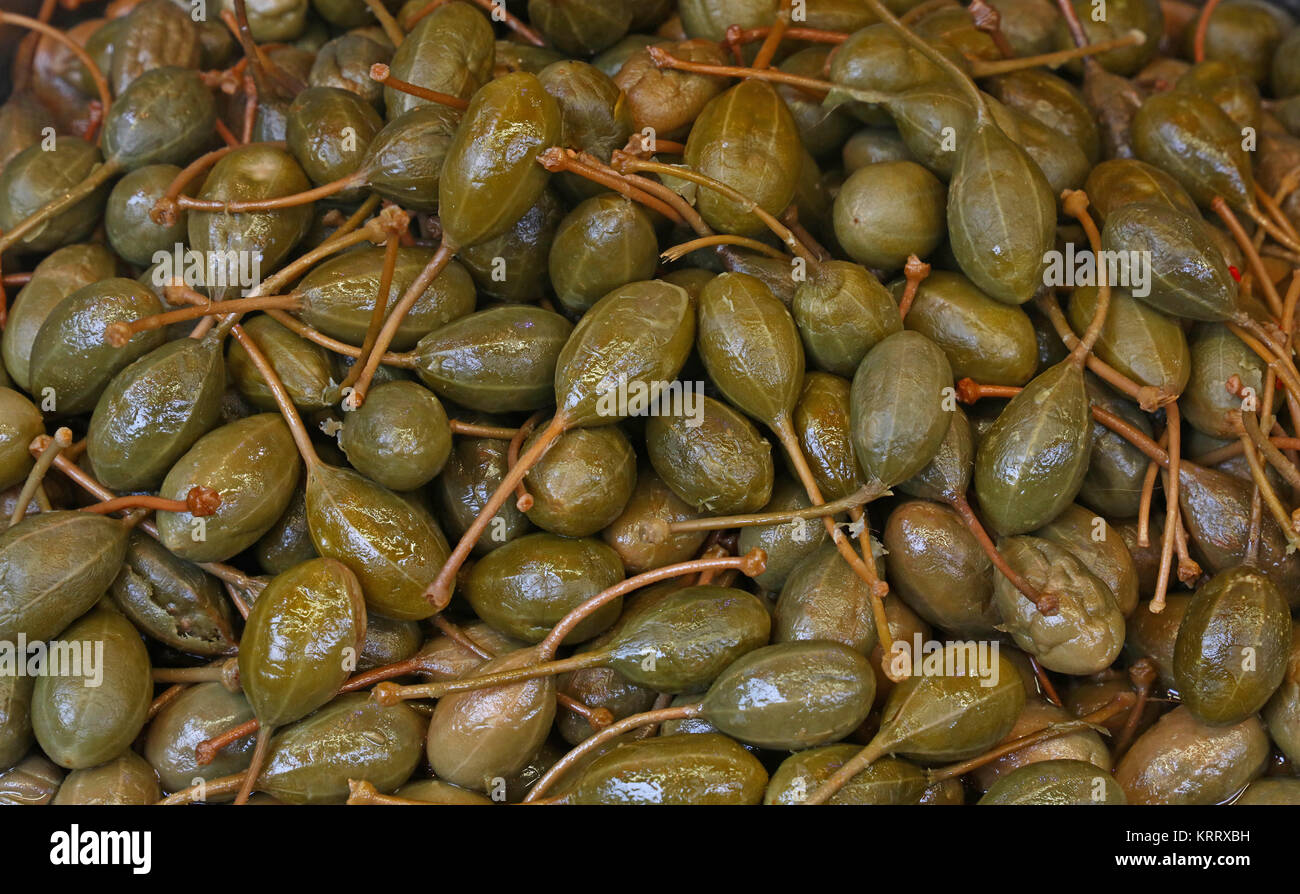 Green pickled big capers close up background Stock Photo - Alamy