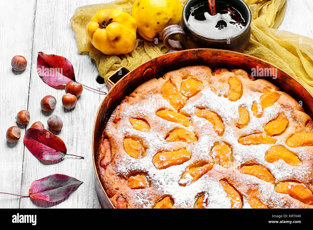 Baked pie with quince in copper kitchen form Stock Photo - Alamy