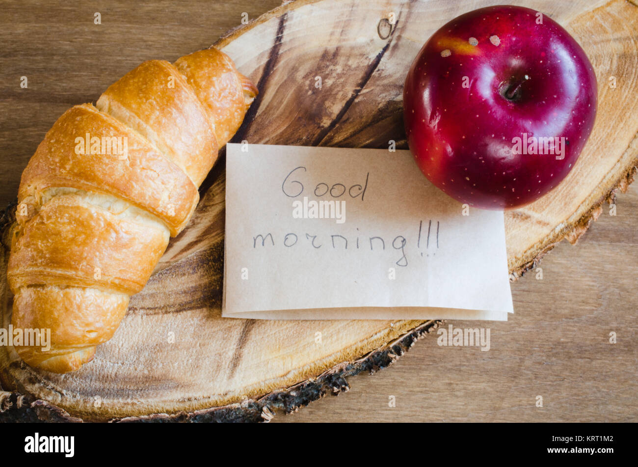 Apple, Croissant and Good Morning Note on Rustic Wooden Background ...