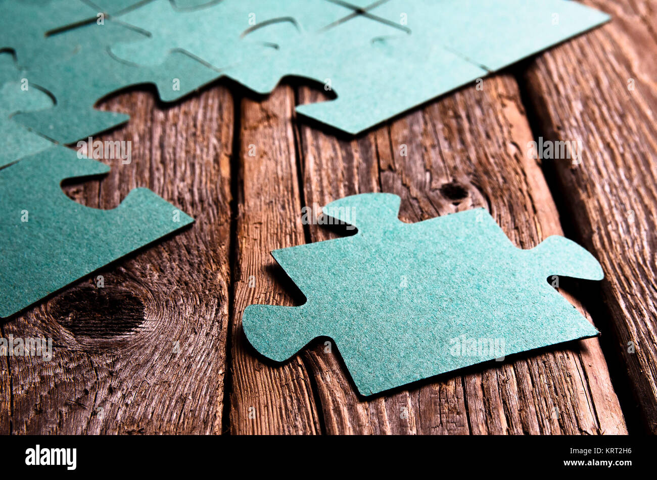 Incomplete puzzles lying on wooden rustic boards Stock Photo - Alamy