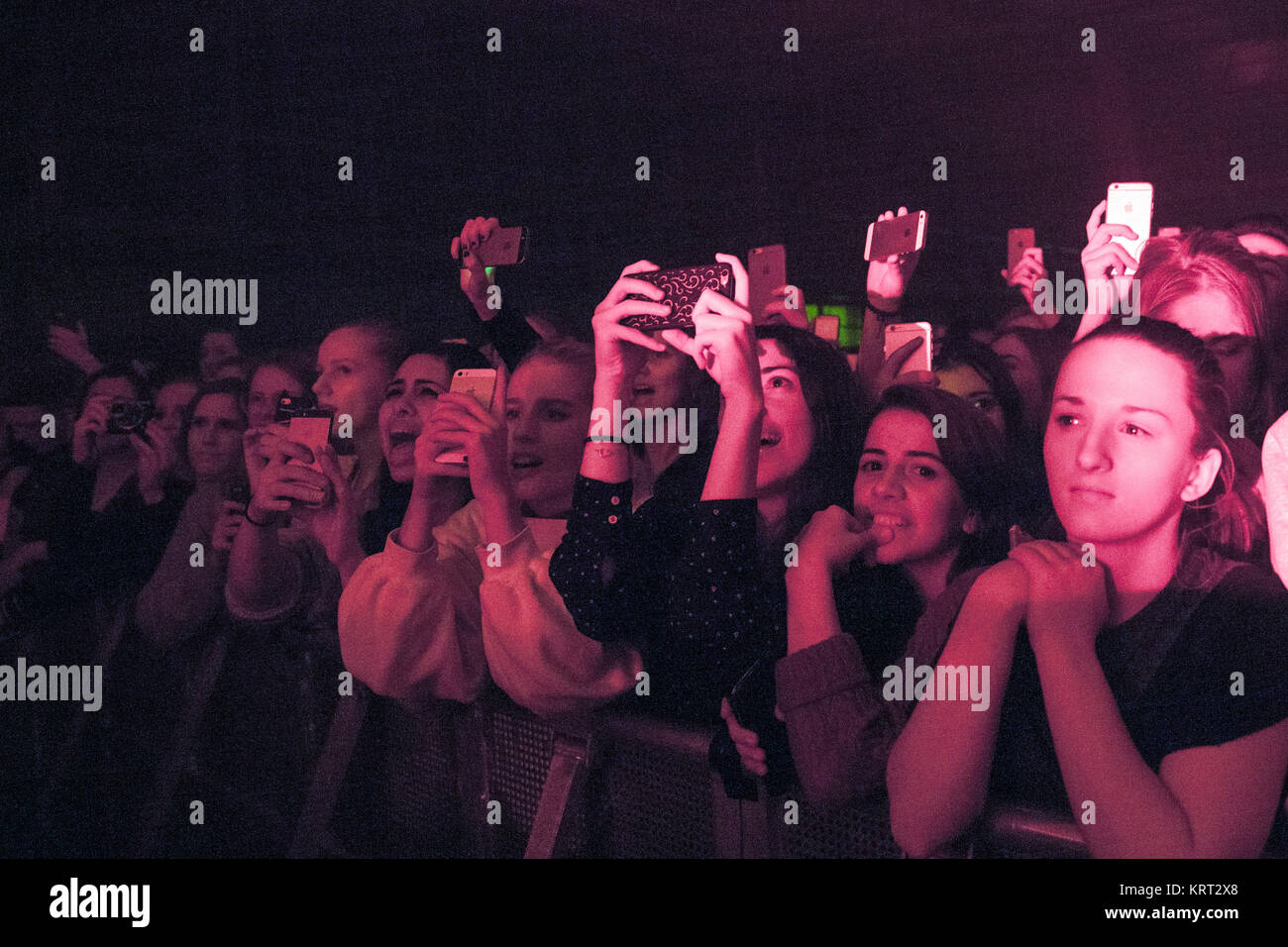 Amused teenagers attend a concert with the British electronica trio ...