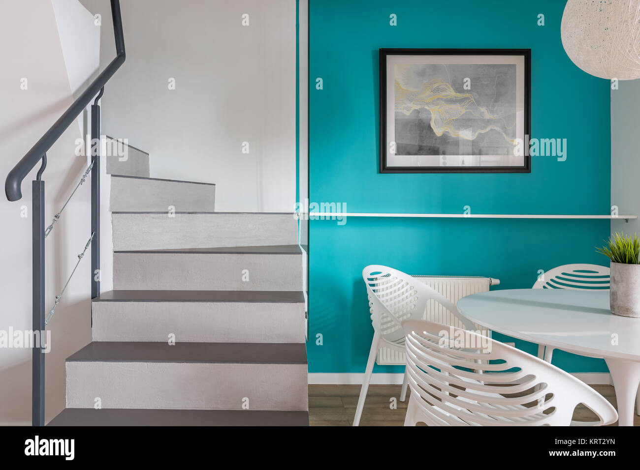 Home interior with stairs, turquoise wall, white table and chairs Stock ...