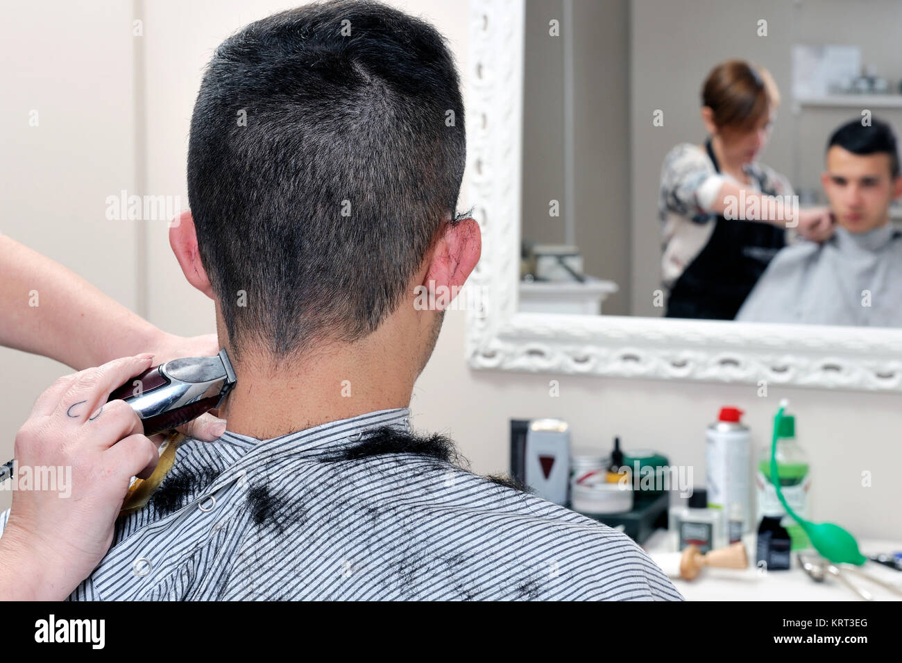 Barber shop that performs the haircut of a young boy with electric ...