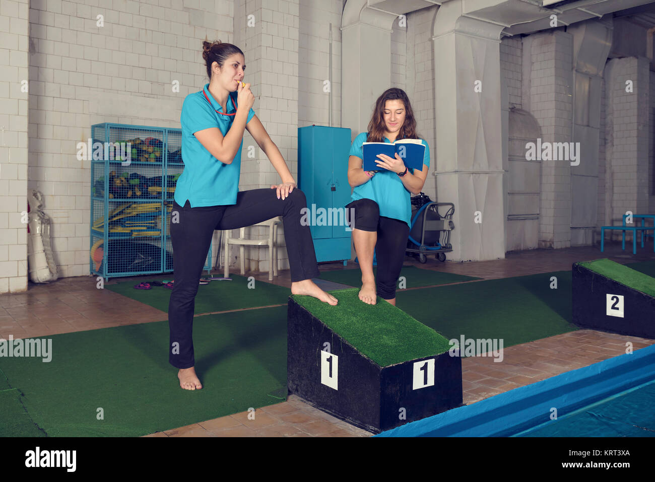 Two Trainers Swimming Pool Stock Photo - Alamy