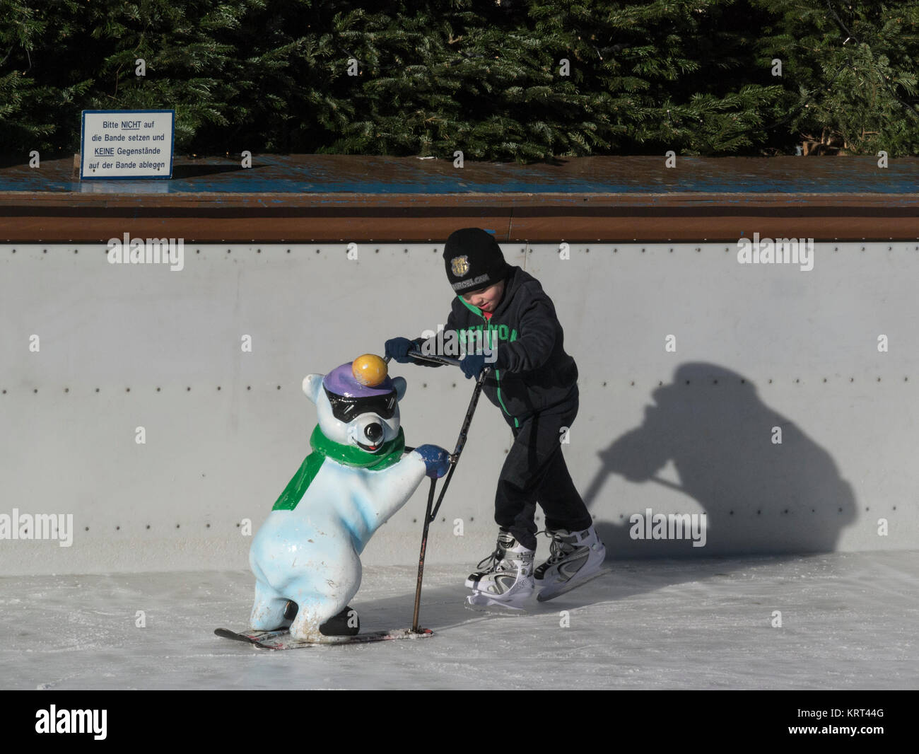 Young boy Münchener EisZauber Munich Ice Magic ice rink holding on to ...