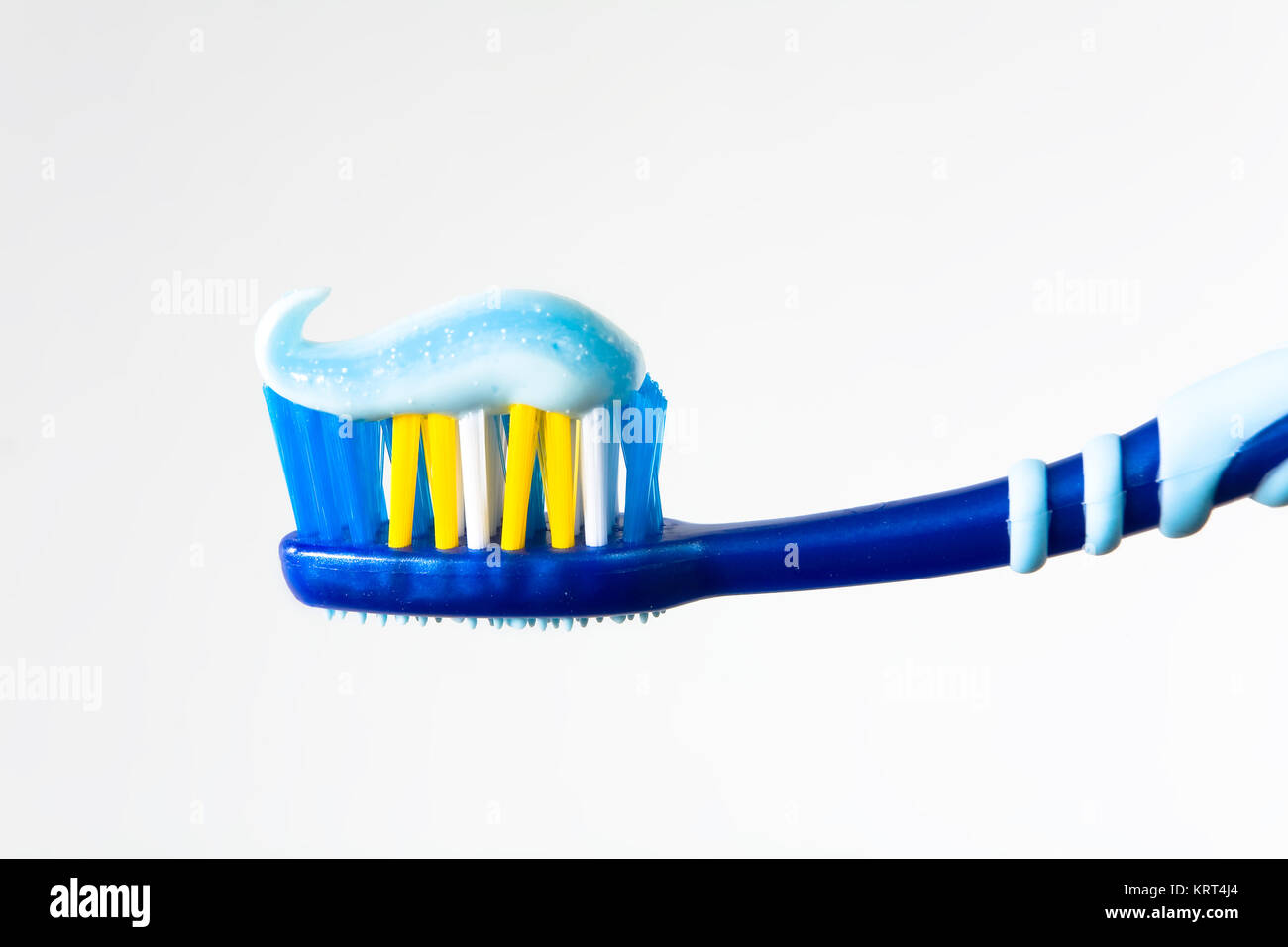 Means of personal hygiene. Blue toothbrush with blue toothpaste on a ...