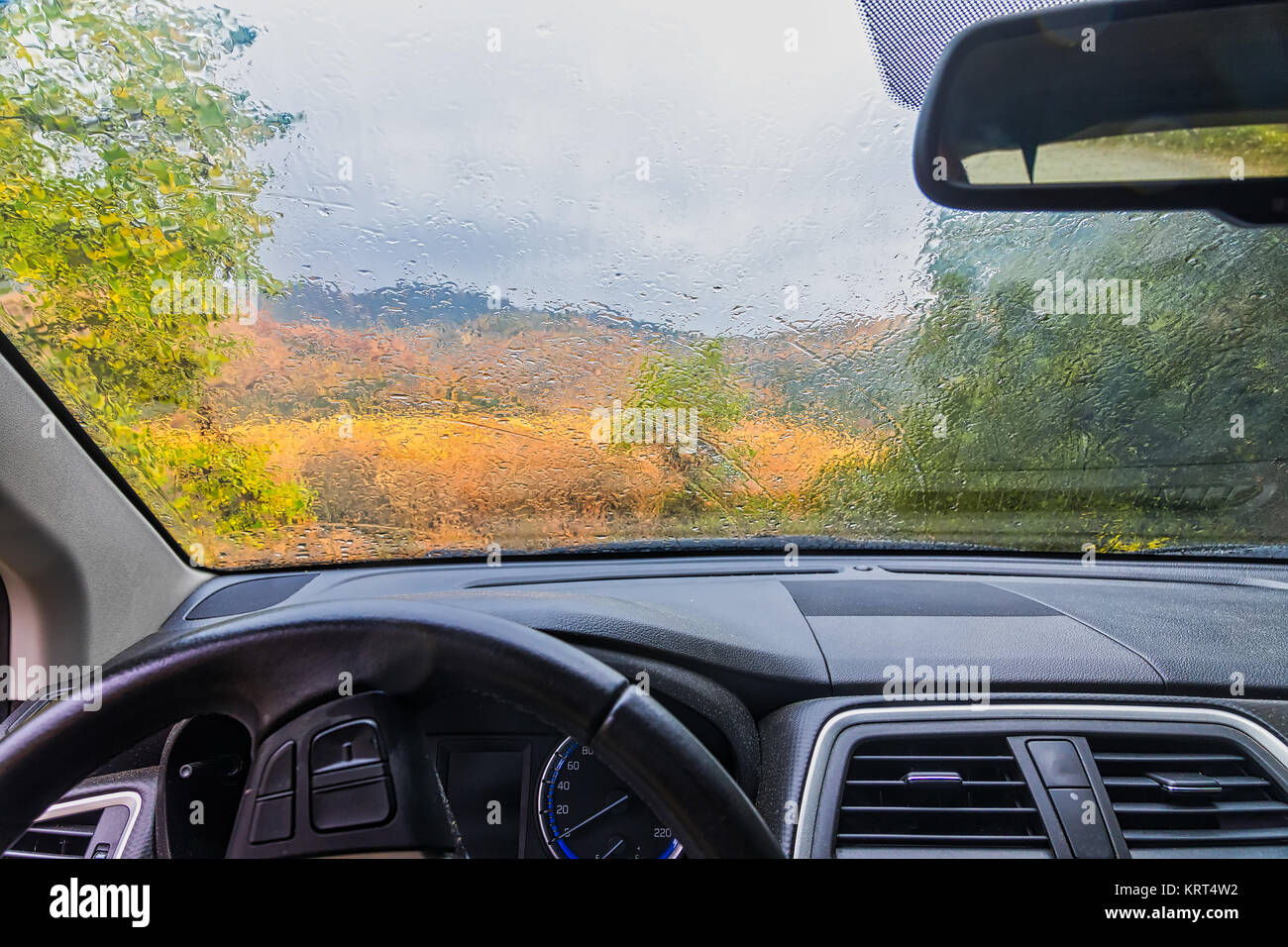 rain drops on the window of the car. autumnal rainy landscape blurred ...