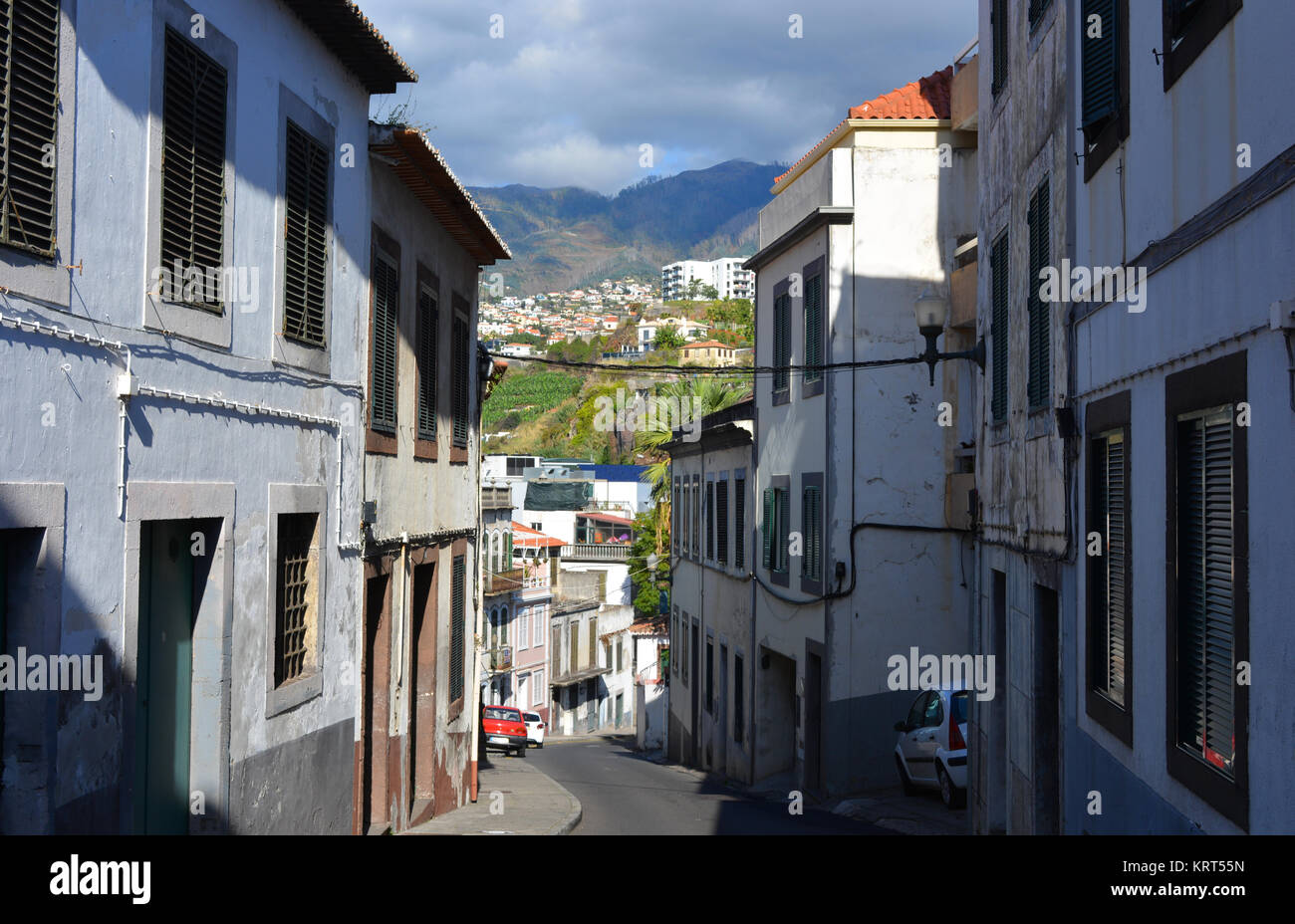 View down a narrow, rundown, residential street in the historic old ...