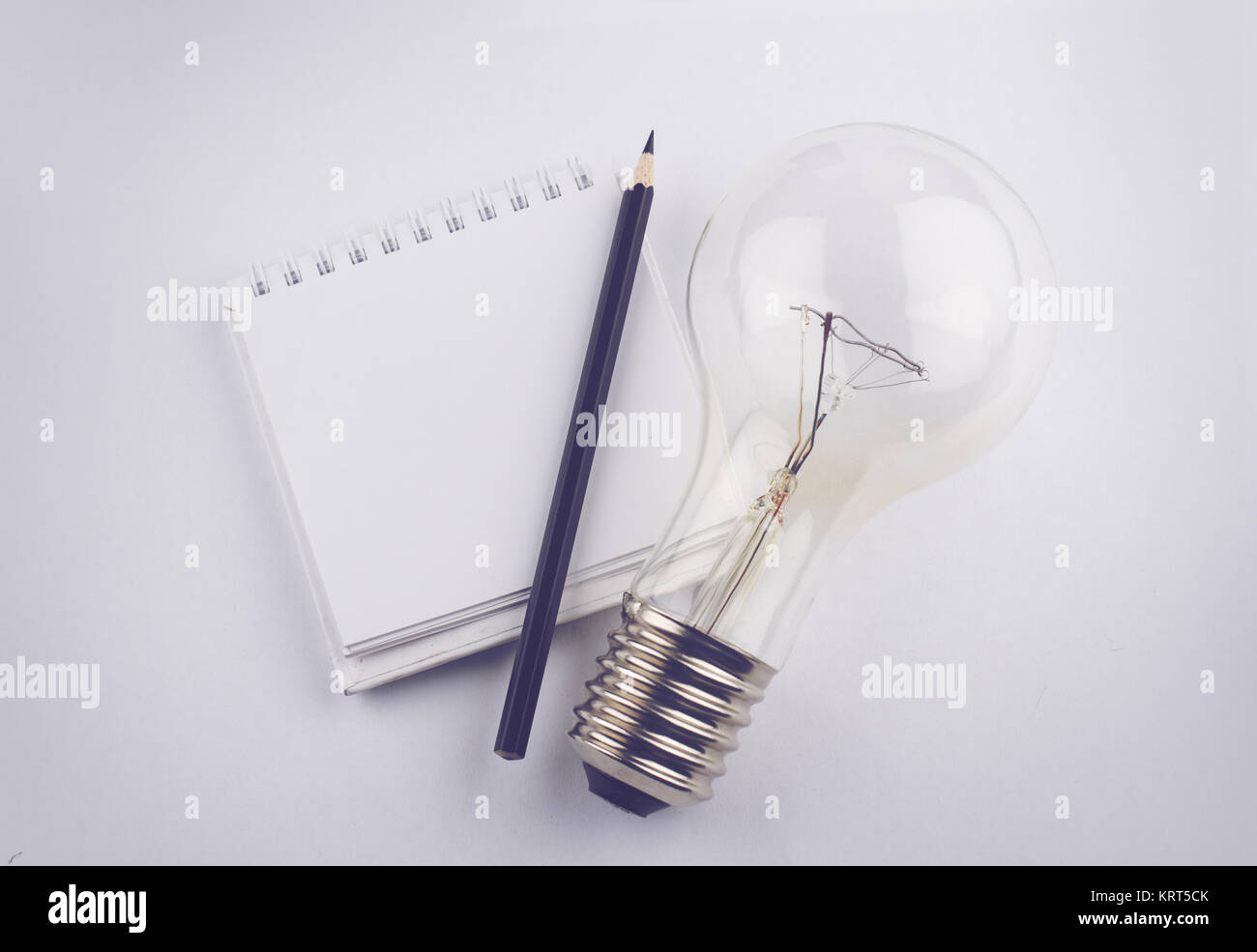 pen notebook and a light bulb Stock Photo - Alamy
