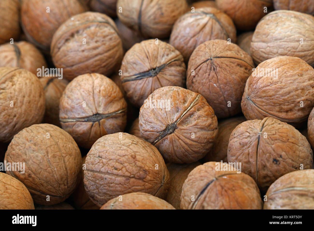 Whole walnuts in nutshells close up Stock Photo - Alamy