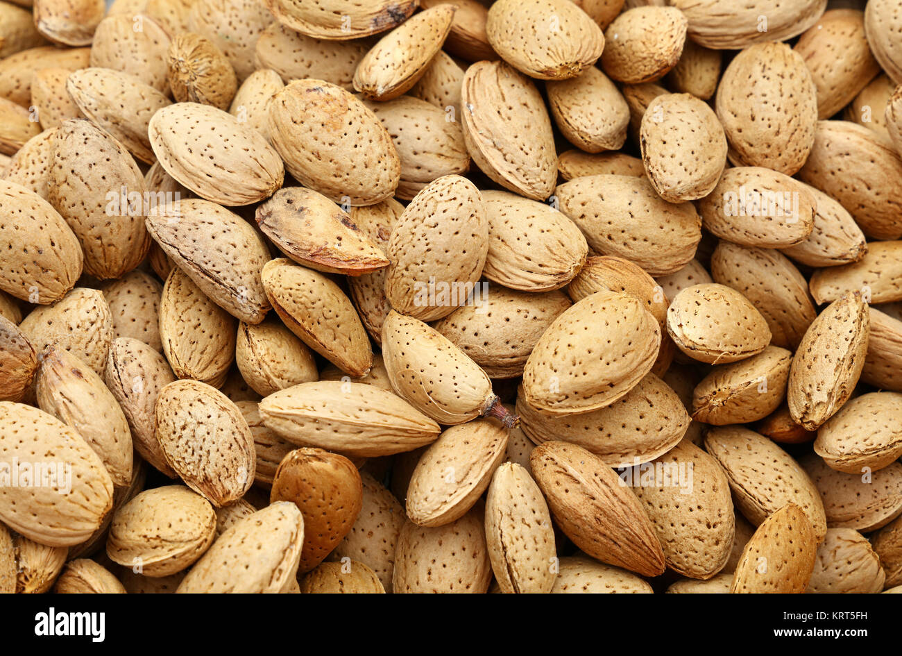 Whole raw almond nuts in nutshells close up Stock Photo - Alamy