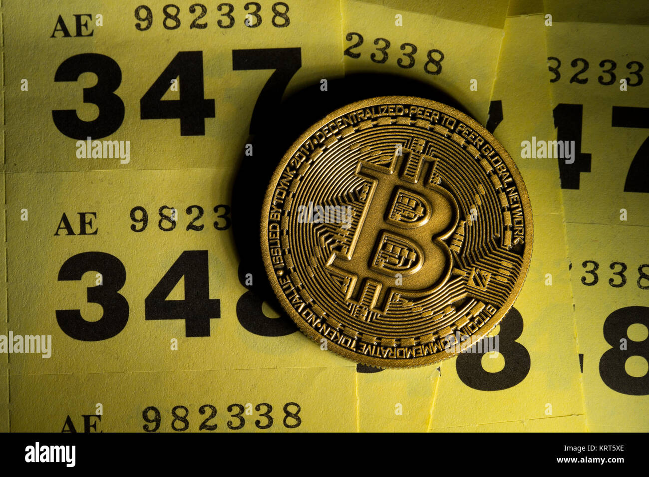Gold Bitcoin coin on raffle tickets Stock Photo - Alamy