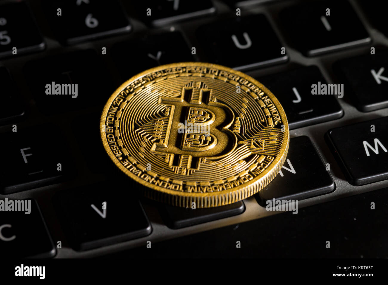 Gold Bitcoin coin on keyboard Stock Photo - Alamy