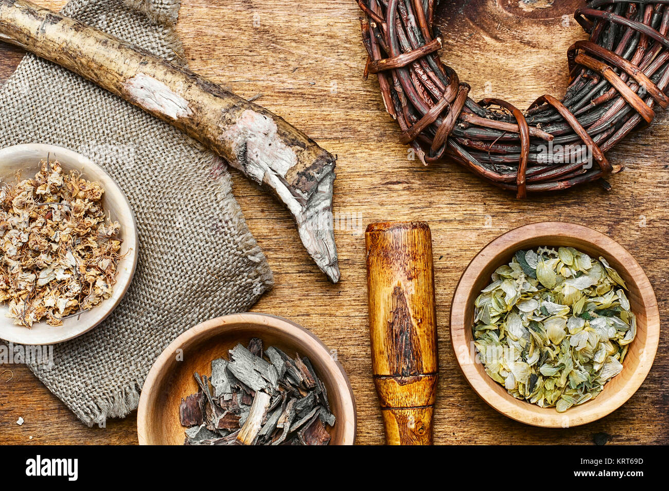 Medicinal herb in the wooden bowl and inula root Stock Photo - Alamy