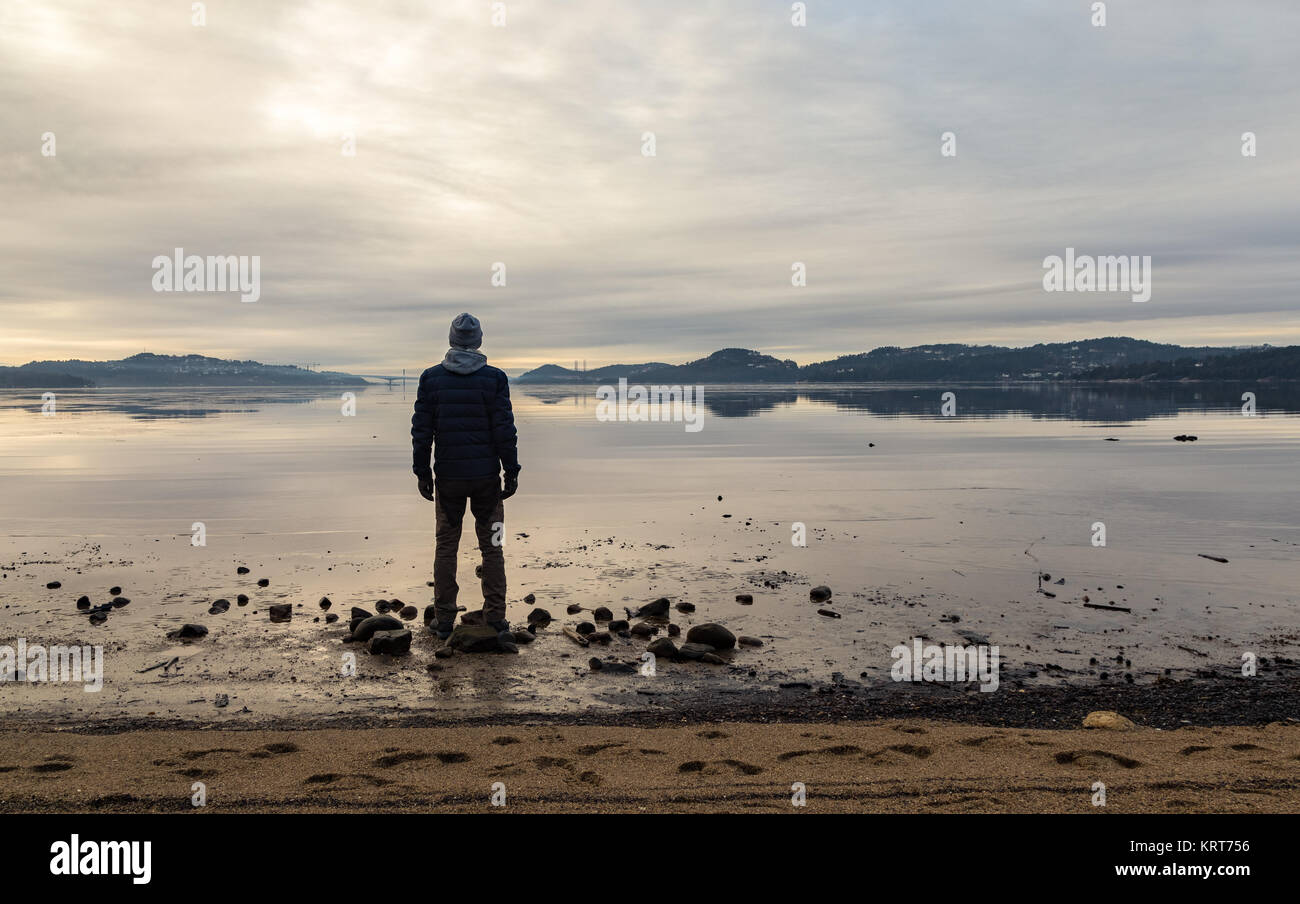 Man standing alone fjord hi-res stock photography and images - Alamy