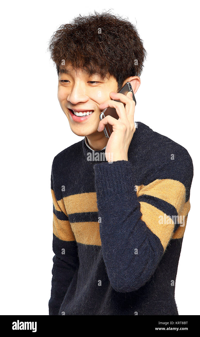 Happy young man talking on mobilephone Stock Photo - Alamy
