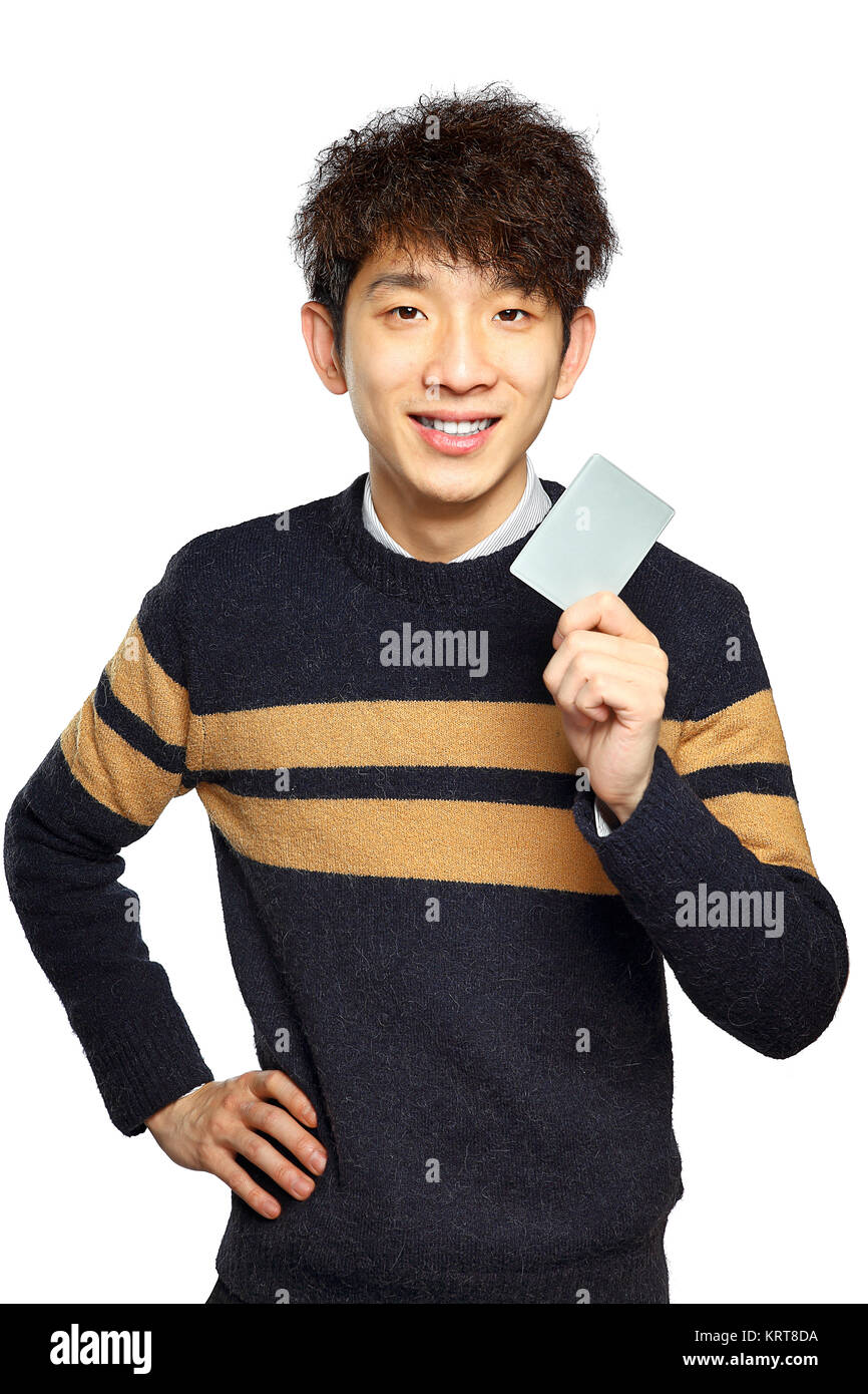 Asian young man holding card Stock Photo - Alamy