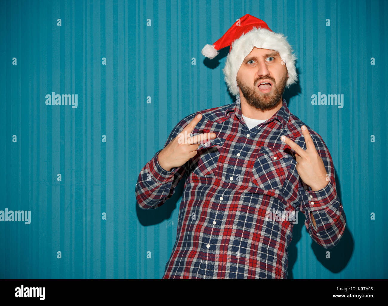 The opinionated christmas man wearing a santa hat Stock Photo - Alamy