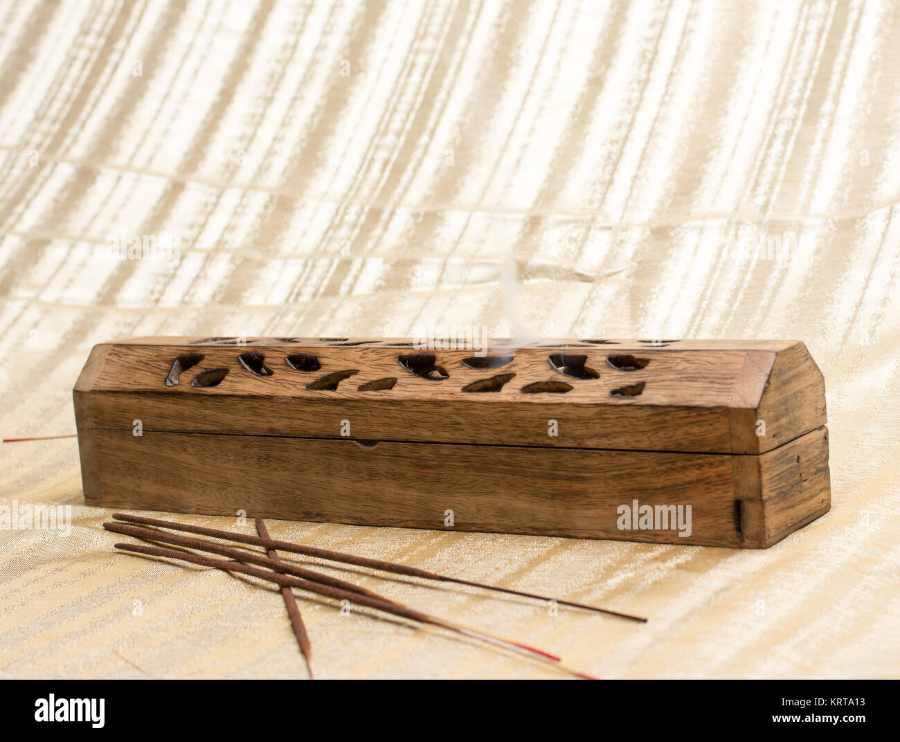 incense box with smoke unburned incense sticks and gold background ...
