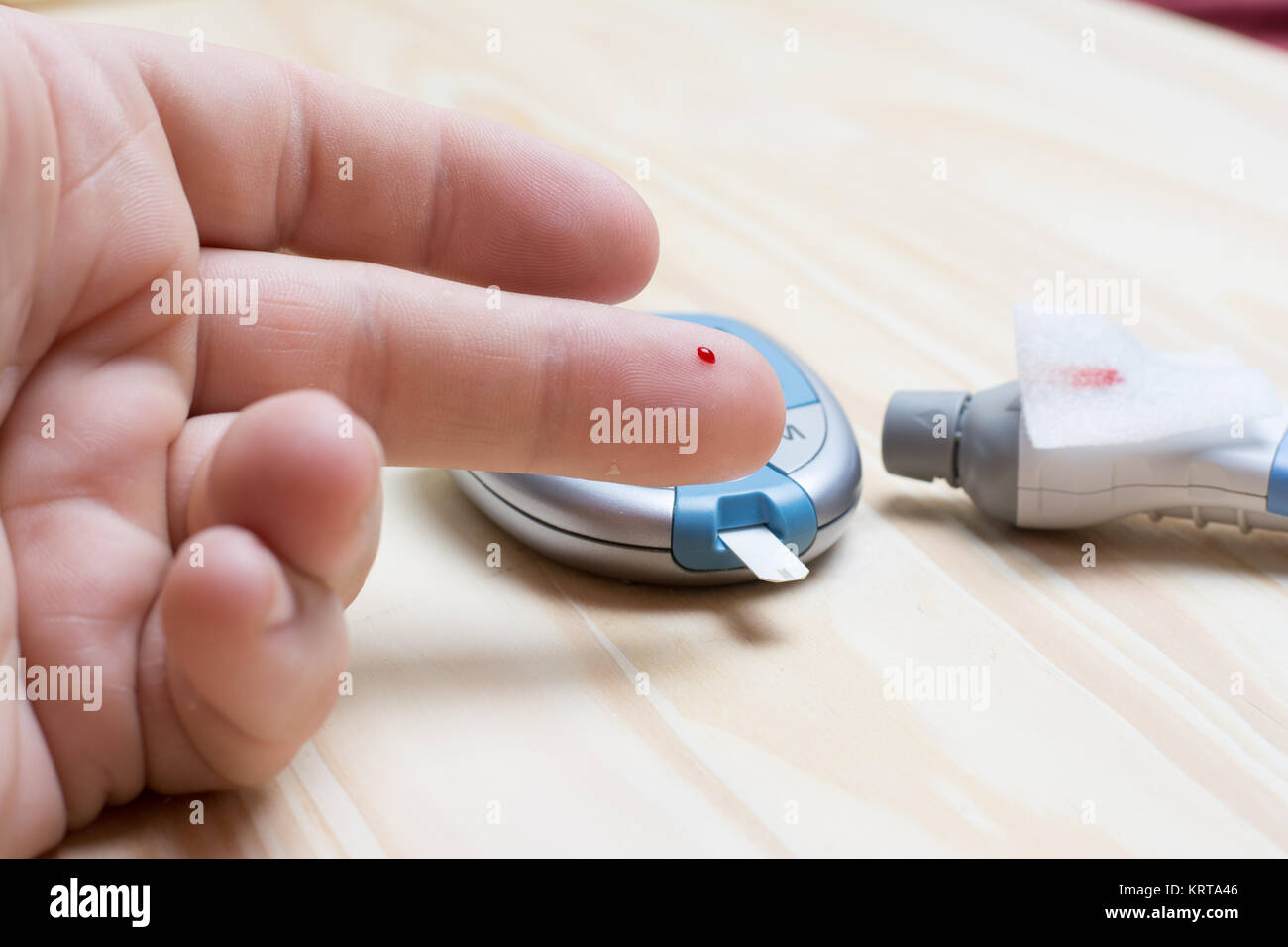 diabetic male hand testing blood sugar drop of blood on finger and ...