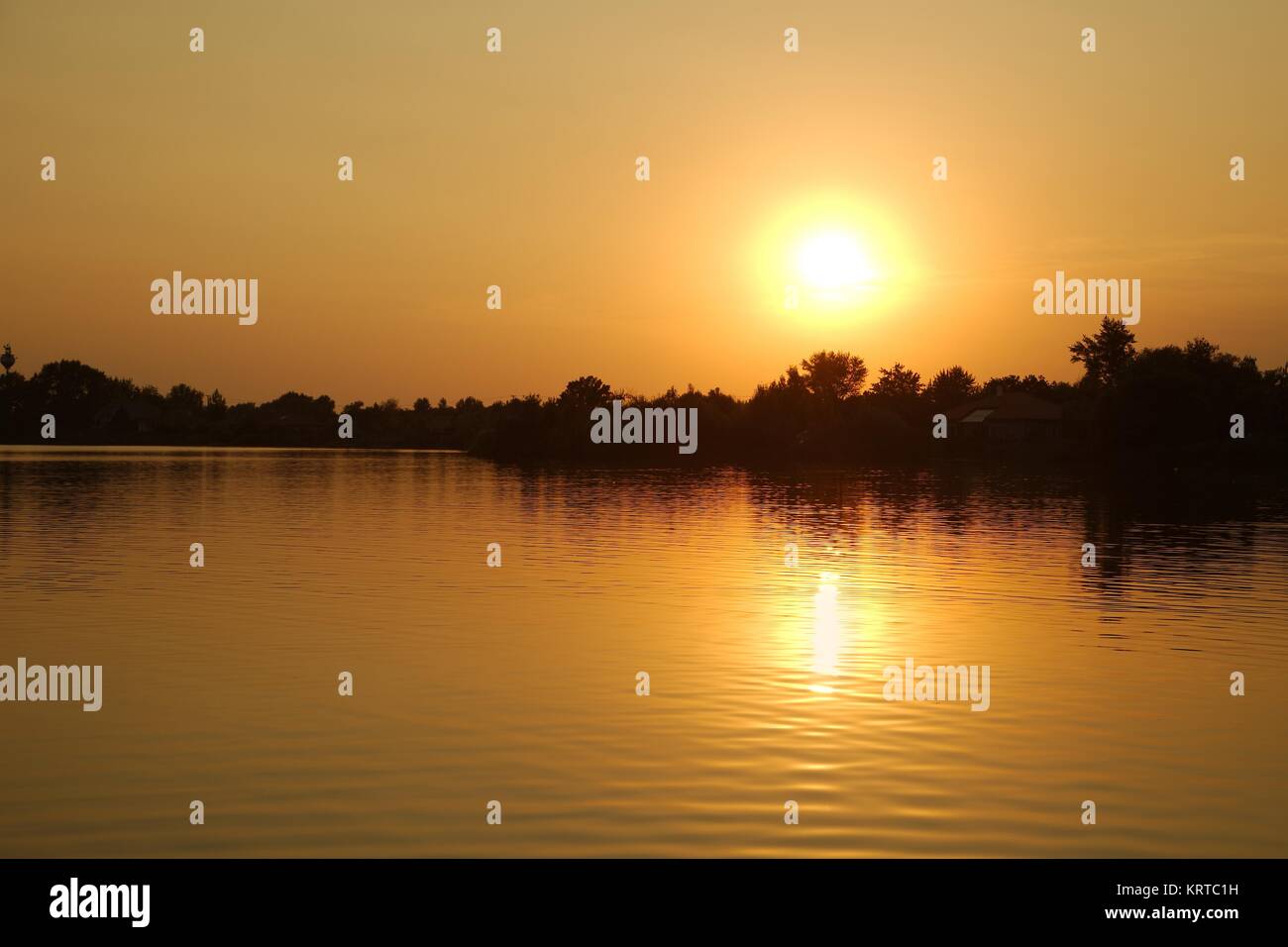 Sunset over water Stock Photo - Alamy