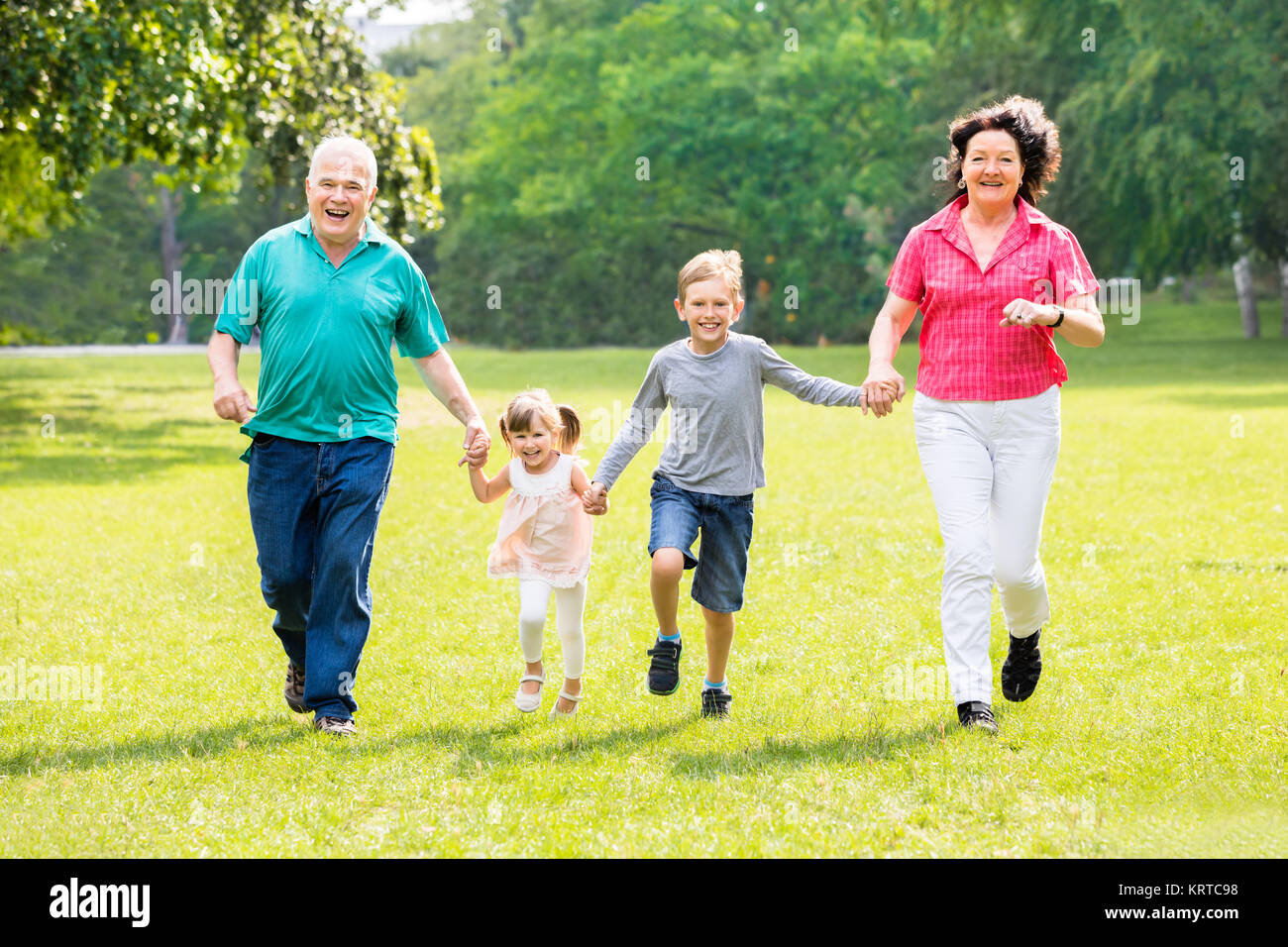 Grandparents And Grandchildren Running In Park Stock Photo - Alamy